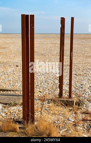 Rusted remnants of metal supports in a shingle landscape with abandoned ...