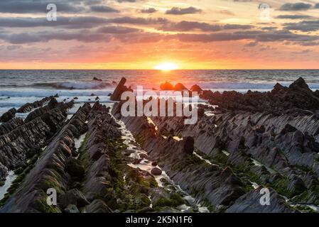 Stunning sunset landscape image of Welcome Mouth Beach in Devon England ...