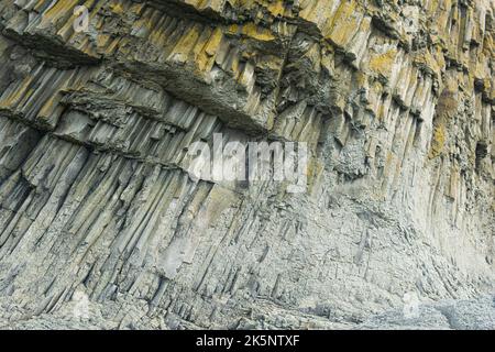 coastal cliff composed of columnar basalt on the island of Kunashir ...