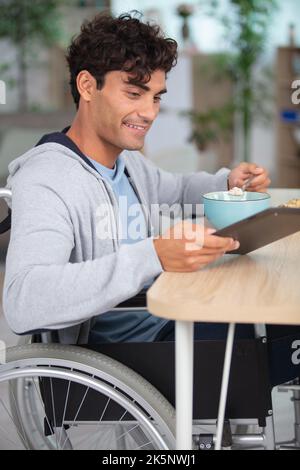 Young disabled injured man opening the fridge door Stock Photo - Alamy