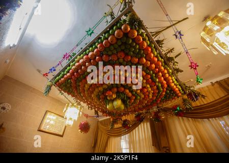 View of the traditional ritual hut decorated with fruits and vegetables ...