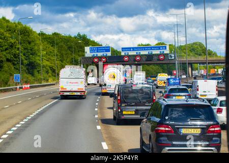 Heavy traffic on M25 London orbital in Middlesex, with A30 slip road ...