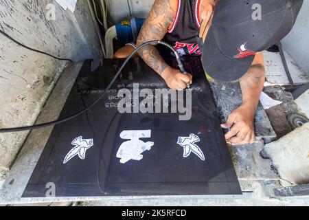 A lapida maker working on a marble tombstone in Cebu City, Philippines ...