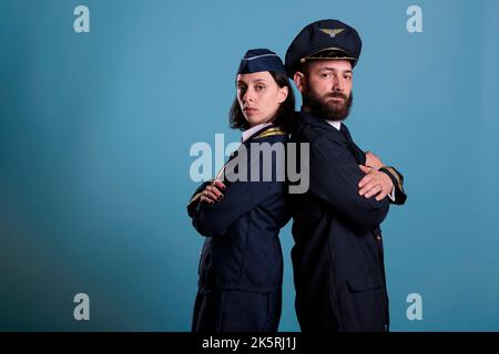 Back view of flight attendant looking away on background of aircraft ...