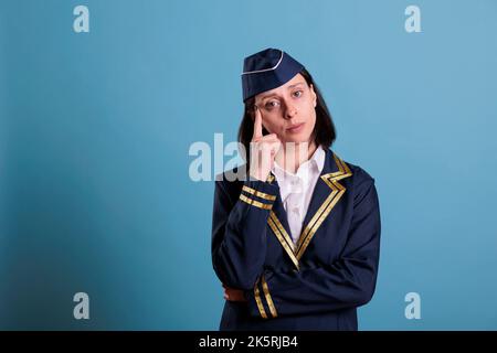 Exhausted stewardess having migraine symptom, touching temples with ...