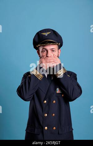 Portrait of captain showing silent gesture, looking at camera with ...