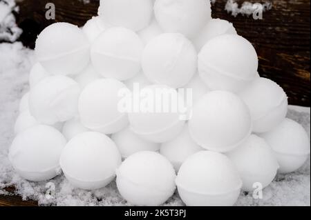 pyramid or a pile of perfect snowballs on frosty winter day in forest ...