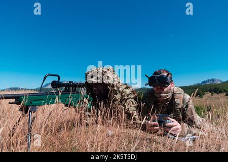Sniper soldier assisted by an assistant to observe the area to be ...