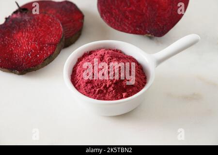 Beetroot powder for cooking healthy beverage in spoon on gray ...