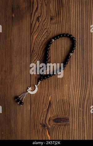 Black Muslim rosary with silver crescent moon. Islamic background Stock ...