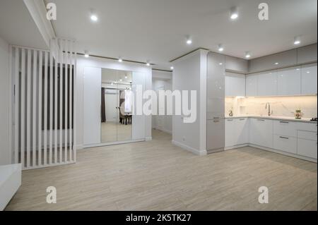 Large white hall connected to room and kitchen in a studio flat Stock ...