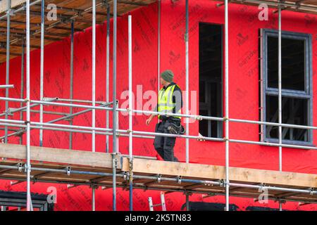 Worker cladding stone for external wall warming Stock Photo - Alamy