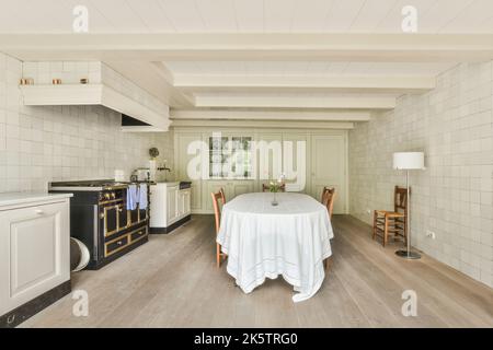 Interior of spacious bright kitchen in Mexican style with black fridge ...