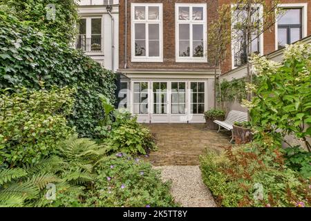Neat powerful patio with sitting area and small garden near wooden ...
