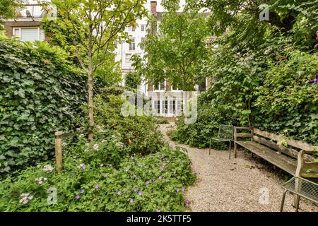 Neat powerful patio with sitting area and small garden near wooden ...