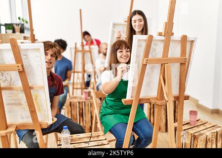Group of young draw students smiling happy standing with hands together ...