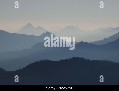 Layered mountain ranges in different shades of blue Stock Photo - Alamy