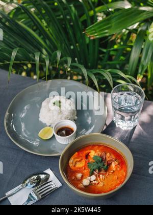 Asian soup 'Laksa' under palm tree at sunny day Stock Photo - Alamy