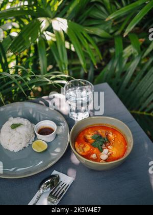 Asian soup 'Laksa' under palm tree at sunny day Stock Photo - Alamy