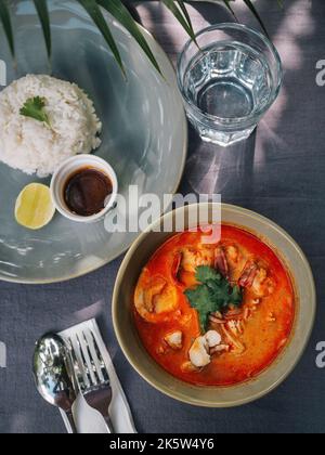 Asian soup 'Laksa' under palm tree at sunny day Stock Photo - Alamy
