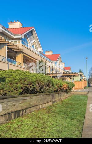 Residential building with red roofs and hedge row on land terrace Stock ...