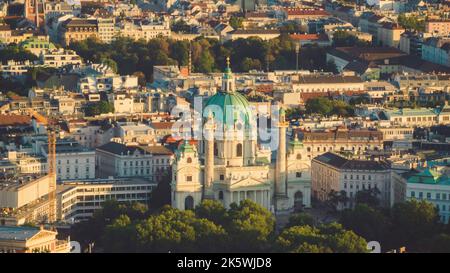 An aerial view of cityscape Vienna surrounded by buildings under blue ...