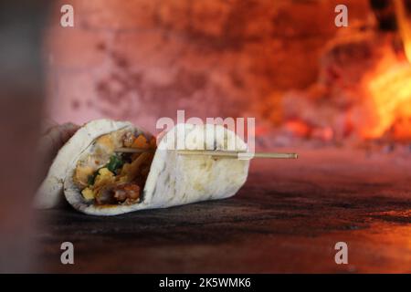 A delicious tacos near the oven with flaming coal Stock Photo - Alamy