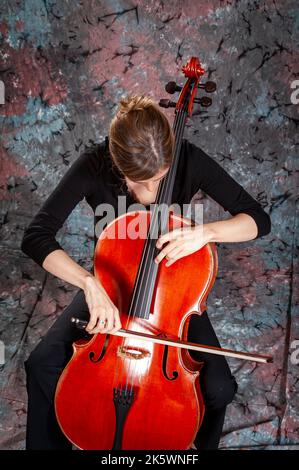 Young female cellist, Cello player in playing position Stock Photo - Alamy