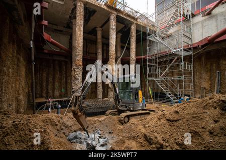 Construction site basement excavation with temporary propping, concrete ...