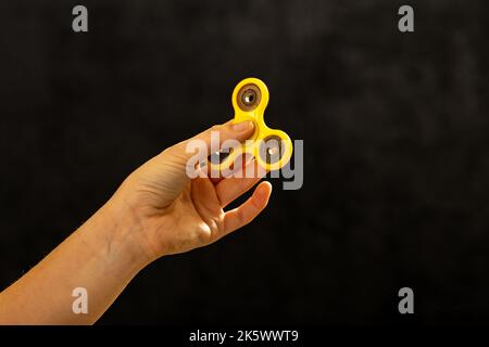 Child playing with a spinning fidget toy Stock Photo - Alamy
