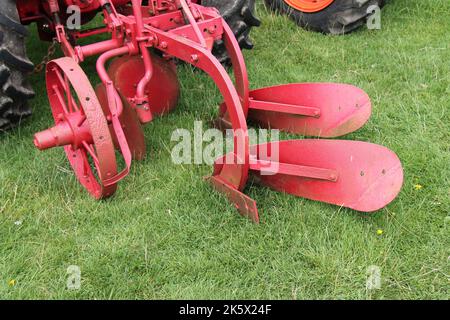 An Old Classic Farming Plough on a Vintage Tractor Stock Photo - Alamy