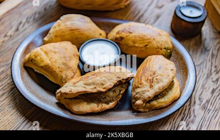 A plate of oven-baked pierogi on a restaurant table Stock Photo - Alamy