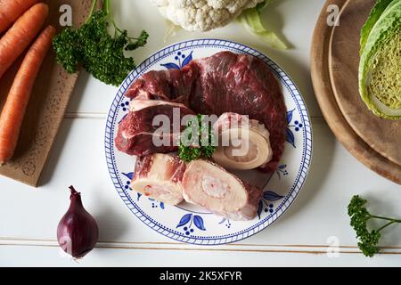 Ingredients for preparing beef broth or soup - fresh marrow bones and ...