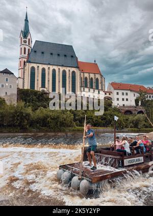 People on wooden raft (vor) on Vltava river in the historical town of ...