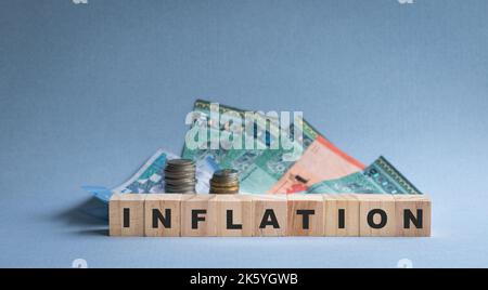Letters of the alphabet Inflation on wood cubes with currency notes and ...