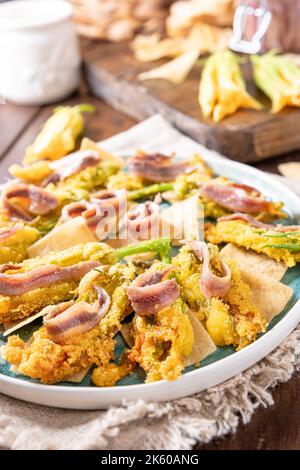 Pumpkin flowers fried with anchovies and cheese. Traditional cuisine of ...