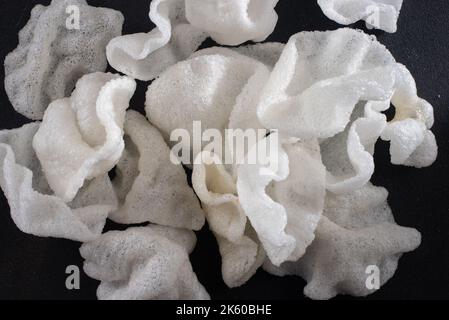 Rice Krispies on a black background. Levitation, chips falling on the ...