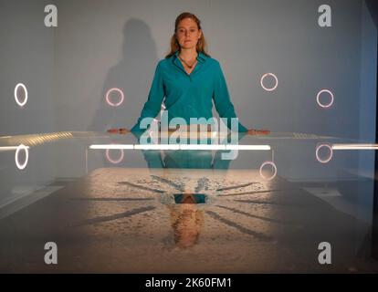 A member of staff observes the Shabaka Stone on display during the ...