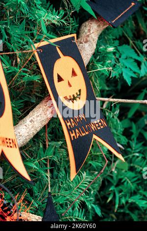 Cute Halloween decorations hanging on a tree in the forest to celebrate ...