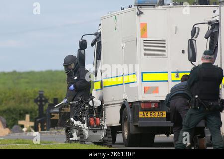 Army Bomb Disposal team are seen in the grounds of St. Coleman's ...