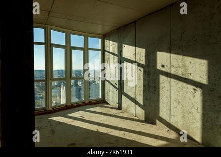 Empty draft rooms in a high-rise building under construction. Shadows ...