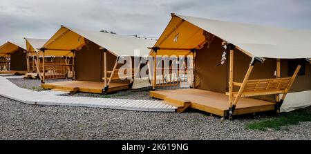 Large wooden framed tents with wooden walkways in a campground Stock ...