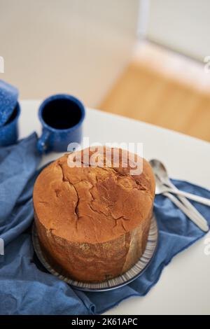 Uncut fresh baked artisan Christmas panettone cake under warm light ...