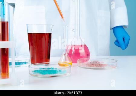 Manipulations with laboratory glass chemical containers on table Stock ...