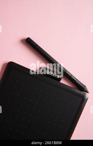 Tver, Russia - February 3, 2020 Top view of Wacom graphic tablet on red ...