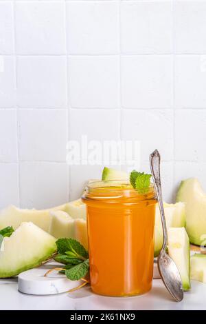 Sweet melon jam, homemade jelly preserves in small glass jar with fresh ...