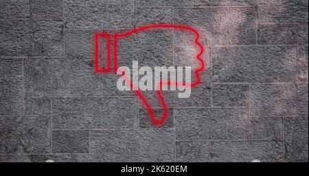 Composite of illuminated digital dislike button icon against brick wall ...
