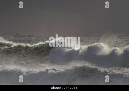Long stormy wave seeing a ship on the horizon. Northern portuguese ...