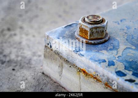 Strong large bolt and nut securing metal to ground strength Stock Photo ...