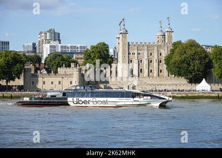 Thames clipper, Uber Boat passing the Tower of London on the River ...